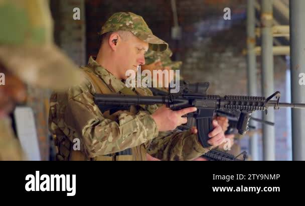 Side view of mixed-race military soldiers loading weapon during ...