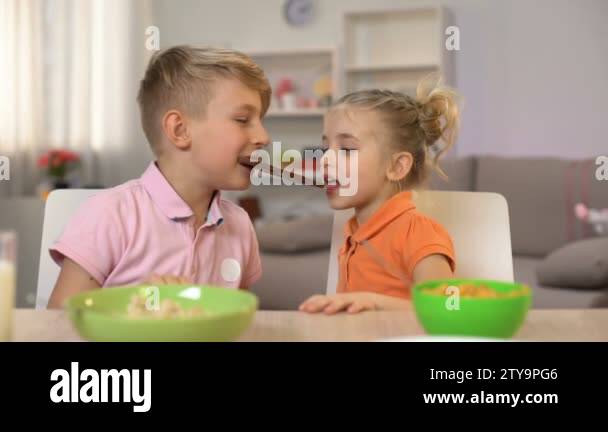 Male and female kids eating chocolate together, brother sharing sweets ...