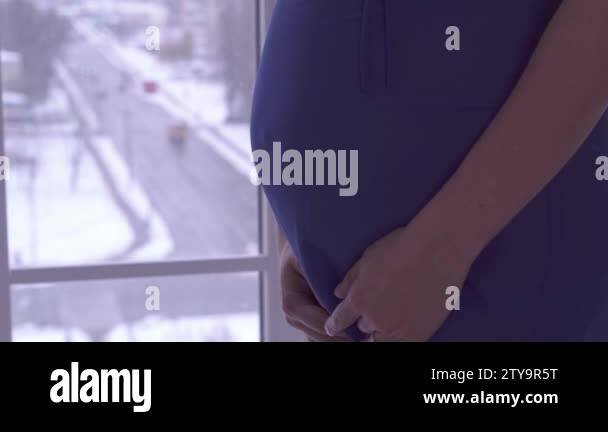 Close up of mom and dad hands on pregnant tummy. Couple caressing ...