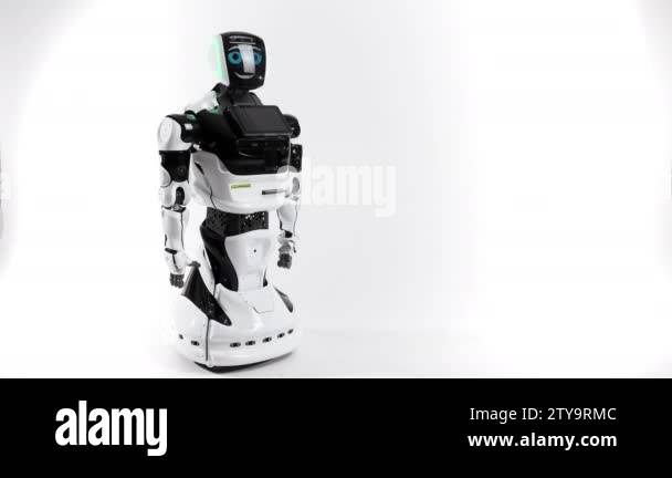 Modern Robotic Technologies. Robot in the bright studio. Android raises ...
