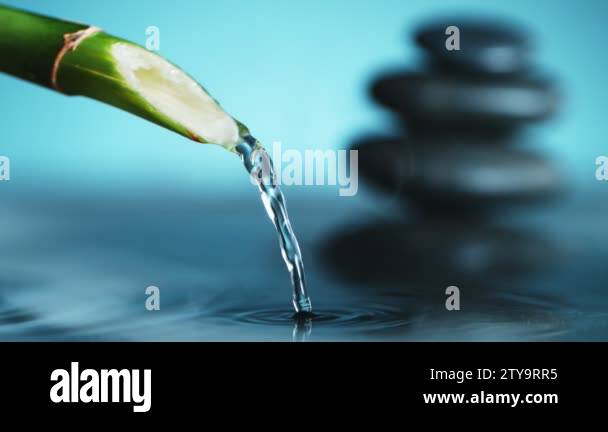 Super slow motion of dripping drops from bamboo, spa and wellness ...