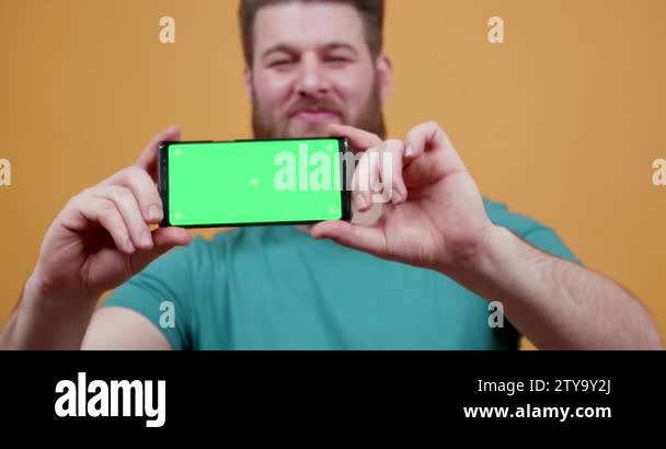 Man proudly shows his phone with green screen on Stock Video Footage ...
