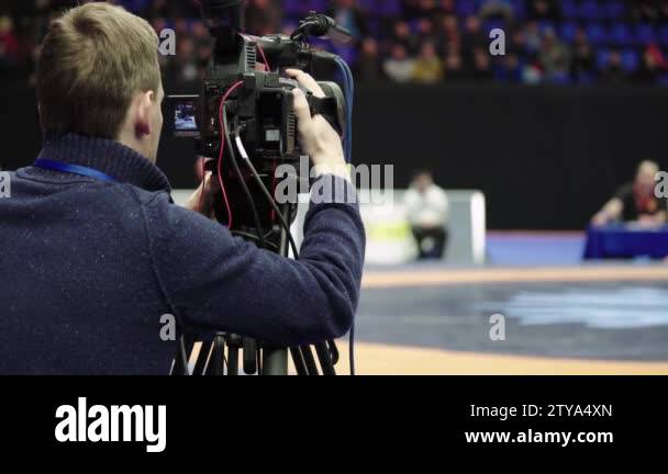 Cameraman with a camera in wrestling competitions. Close-up Stock Video ...