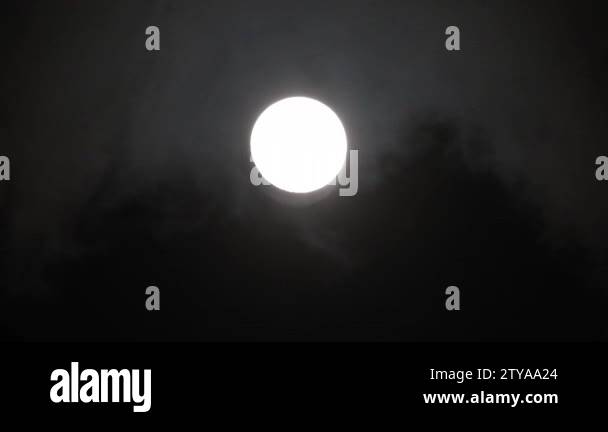 Full moon on dark cloudy night. Clouds passing by the moon, real time ...