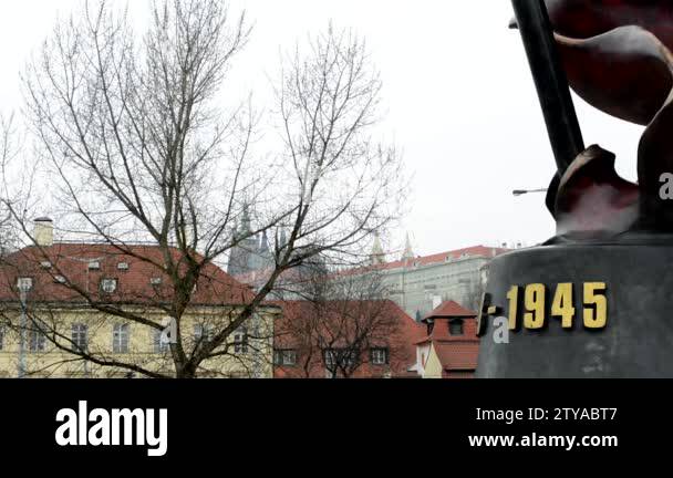 Prague castle with other buildings (tree) and statue (end of world war ...