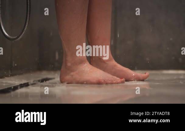 Woman s legs close-up. Girl washing with gel in shower. Beauty care ...