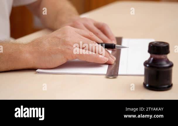 Mans hands drawing lines with ruler and brush pen. Close shot. Side ...