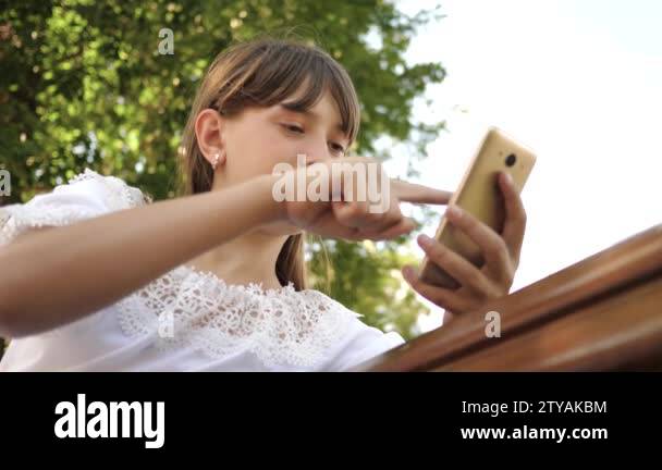 Happy Girl Using Smartphone Flipping Through Pages On The Internet In A 6190