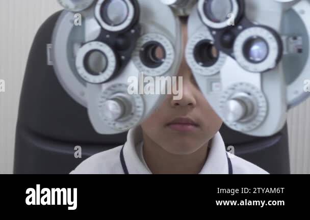 Little boys eye examination at optometrist ophthalmologist using ...