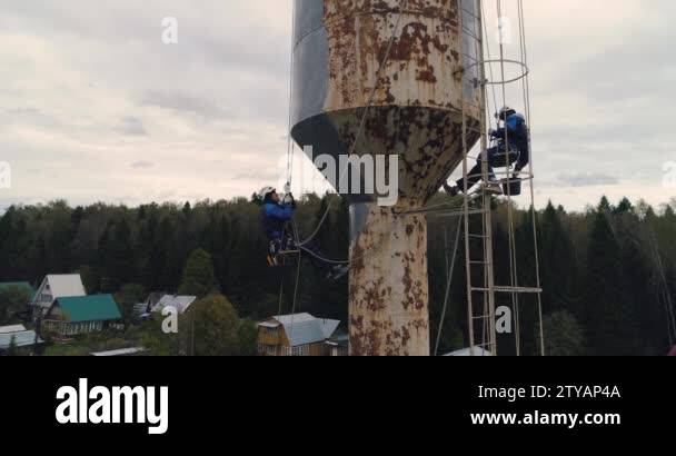 industrial climbers paint the iron tower. Risky job. Extreme work ...