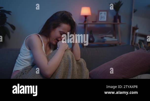 Lonely sad girl sitting on sofa in fetal position and crying. Depressed ...