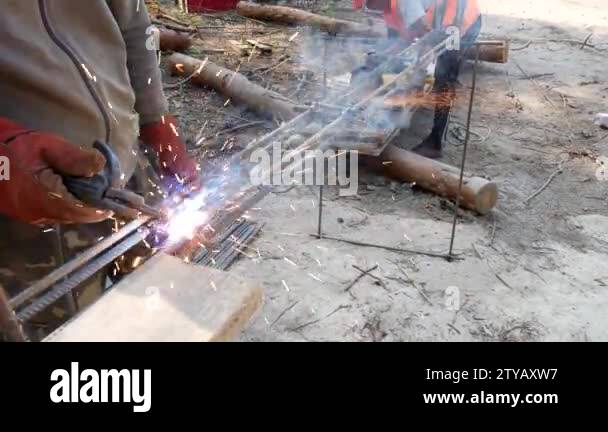 Welder electrode welds the septum between the rods. Hand welder in ...