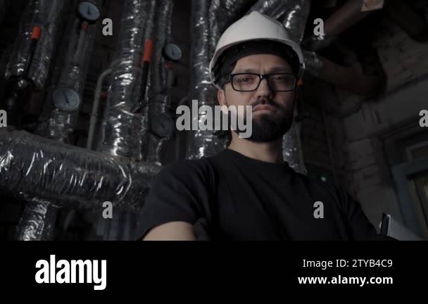 Man standing in a boiler room or a technical room with hot pipes Stock ...
