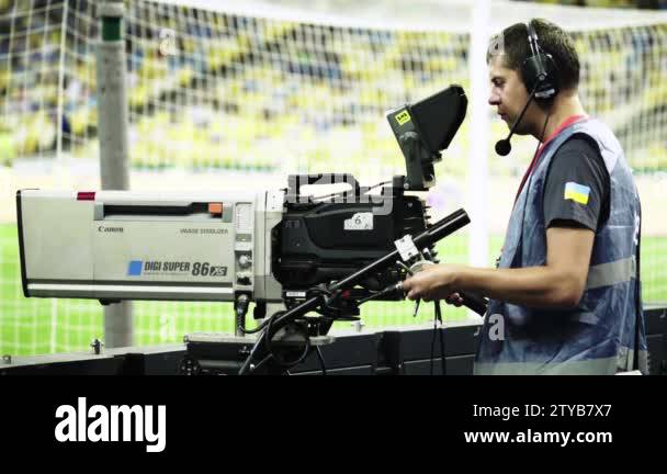 Cameraman with a camera in the stadium during a football match. TV ...