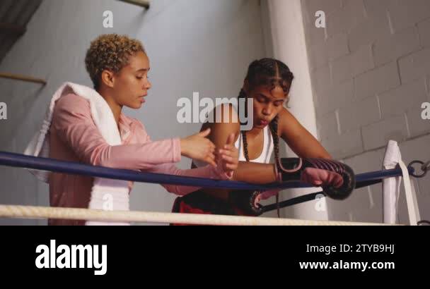 Front view of a mixed race female boxing coach with short curly hair ...
