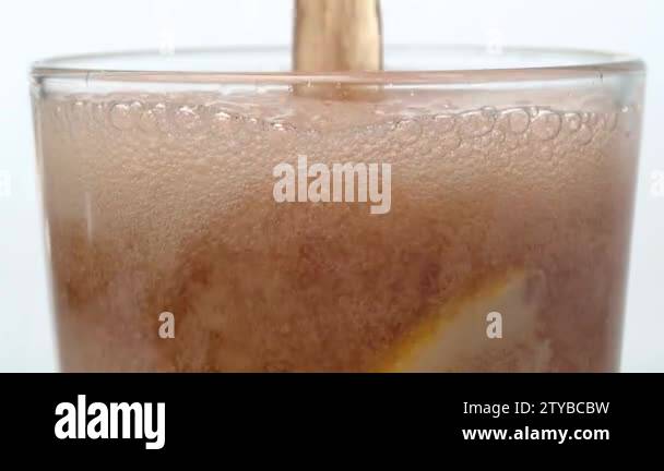 A Jet Of Cola Pouring Into A Glass Rising Foam Ice Cubes And A Slice