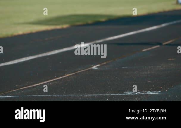Woman runner hold her injured leg on track. Having stopped, he put his ...
