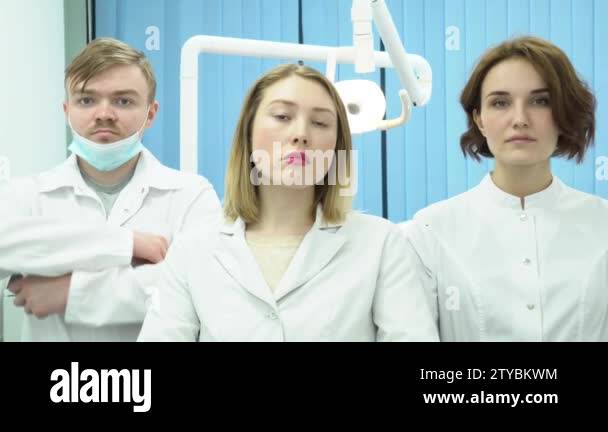 Team of doctors stand with their hands crossed. Media. Three doctors in ...