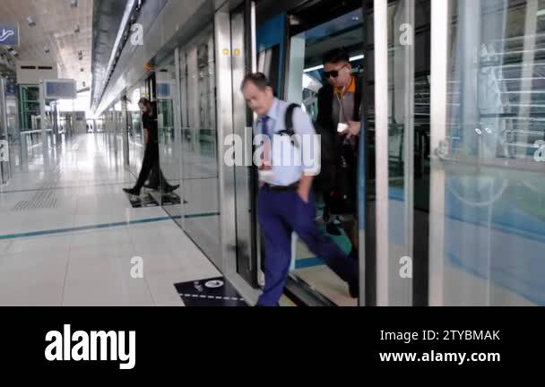 People get out of the electric train at the Dubai Metro station Stock ...