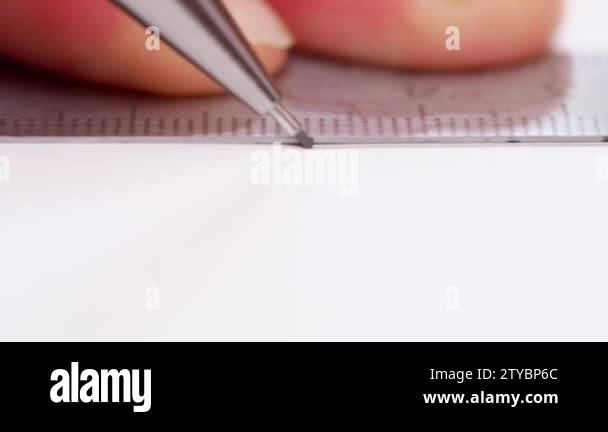 Calligraphist drawing a line with brush pen and iron ruler. Preparing ...
