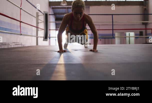 Front view of a mixed race female boxer with short curly hair wearing a ...