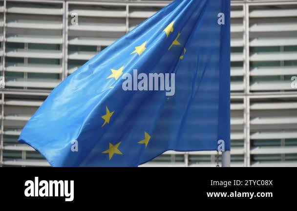 Huge EU flag flying optimistically at the European Commission in spring ...
