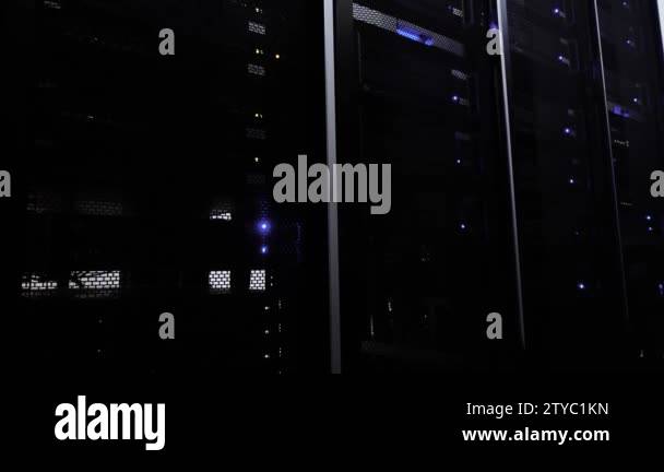 Working Data Center With Rows of Rack Servers. Blue light. Dark server ...