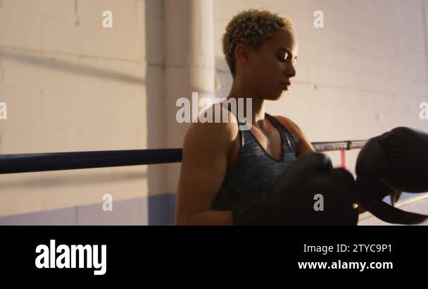 Side view of a mixed race female boxer with short curly hair at a ...