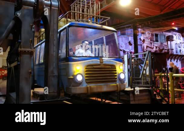 indoor carnival theme park - An asiatic family on crazy flying bus ride ...
