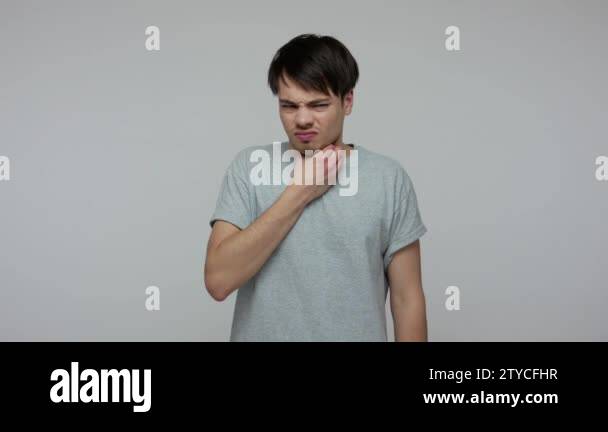 Neck pain. Young brunette man having sore throat, respiratory infection ...