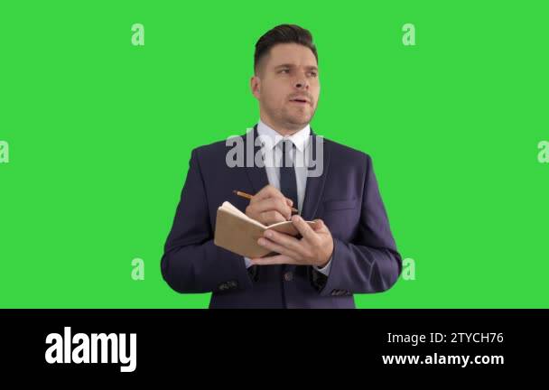 Businessman putting down ideas and filling in checklist on a Green ...