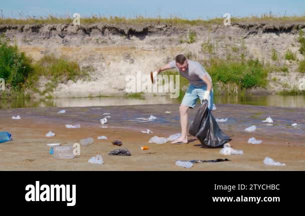 Angry man collects plastic trash on banks of polluted river, then drops ...