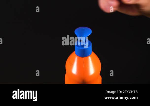 Orange bottle of detergent. Bottle without labels and name. Hand ...