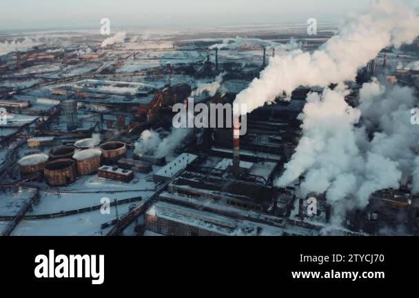 Drone panning of industrial park, many smoke stack pipes of steel plant ...