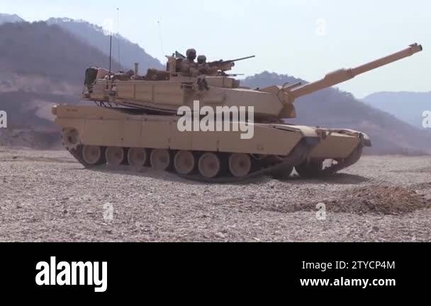 M1 Abrams tank driving on sandy terrain Stock Video Footage - Alamy