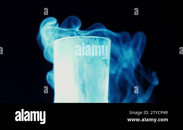 Flask with liquid nitrogen on black background. Concept of chemical ...