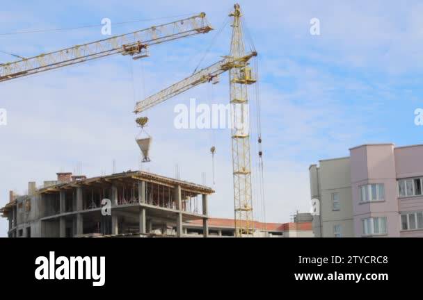 Work tower crane at the construction site. The crane moves the concrete ...