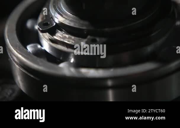 Rotating metallic ball bearing spinning in a dark modern auto ...