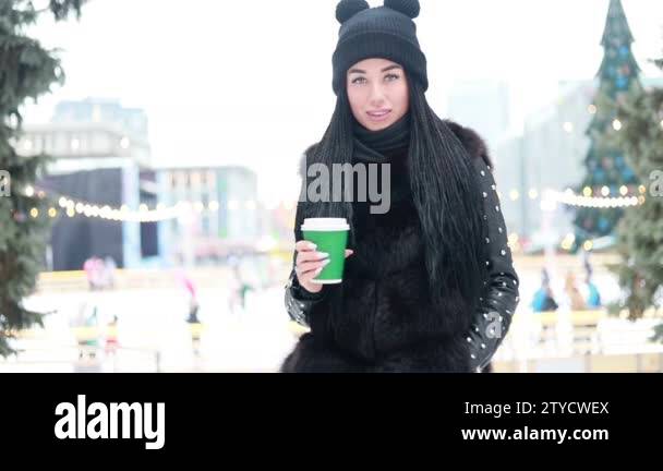 winter holidays, hot drinks and people concept - The girl is drinking ...