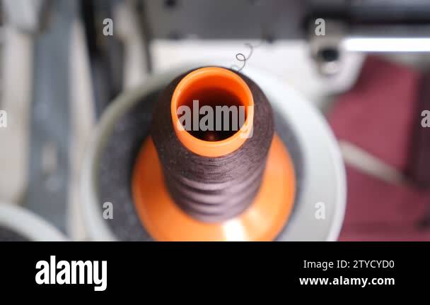 Spinning thread in Wound on Robbin on sewing machine. Close-up of Spool ...
