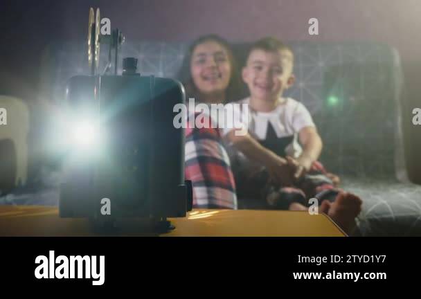 Kids watching a cartoon on an old movie projector Stock Video Footage ...