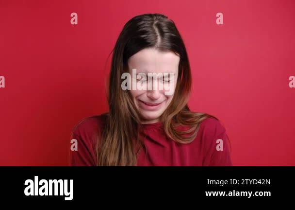 Unhappy woman frowns face, has disgusting expression, shows tongue ...