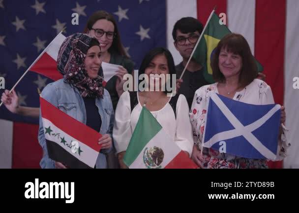 Group of people with different ethnicities holding flags from various ...