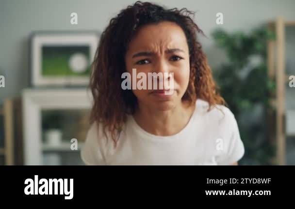 Portrait of outraged mixed-race woman yelling, crying, making unhappy ...