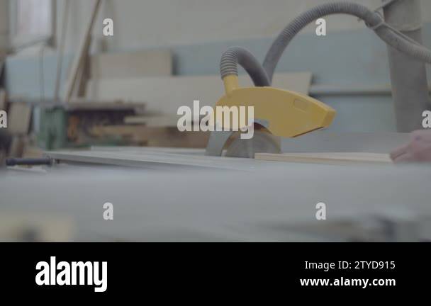 Carpenter working on a circular saw machine. Wooden furniture ...