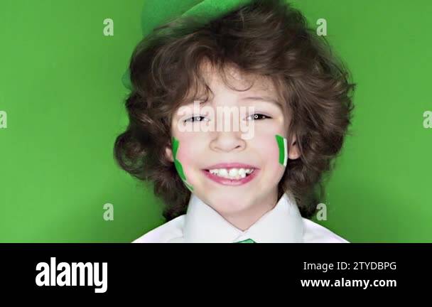 Child Celebrating St. Patrick's Day looking at the camera. A small ...