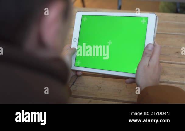 Young 20s guy using tablet with touching screen for internet surfing on ...