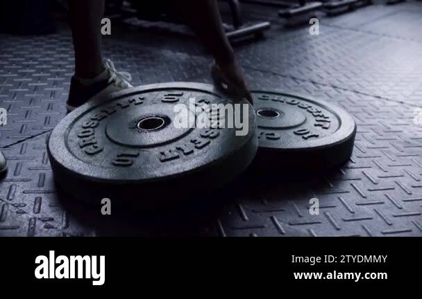 Close up for heavy weight plates on the gym floor ready to be used by a ...