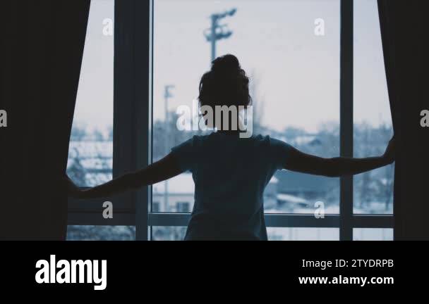 Young models in a modern high-rise house with full length windows ...