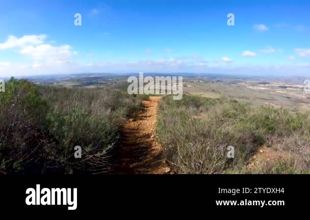 Walking through small trails to the top of the Black Mountain in San ...